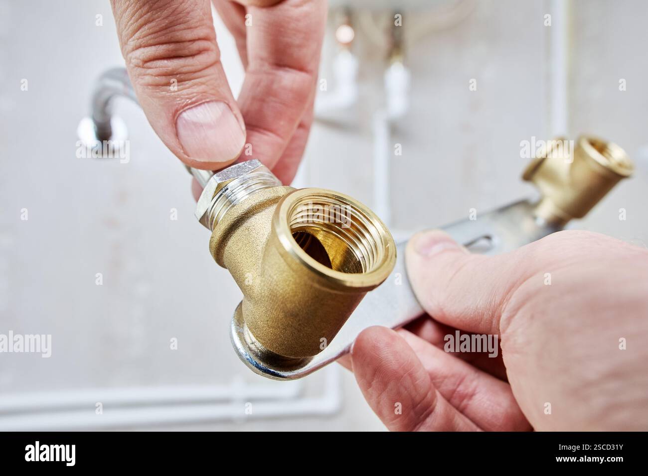 Connecting flexible water hose to brass plumbing fitting Stock Photo ...