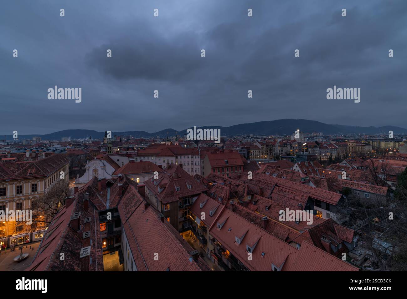 Blue hour evening on hill in center of winter cloudy city Graz Austria ...
