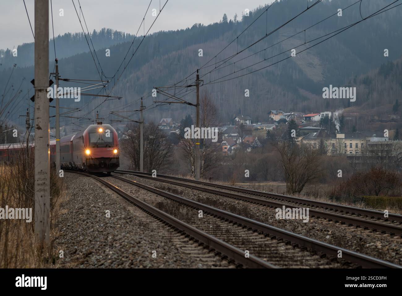 Dark cloudy morning near railway with electic unit train near Kindberg ...