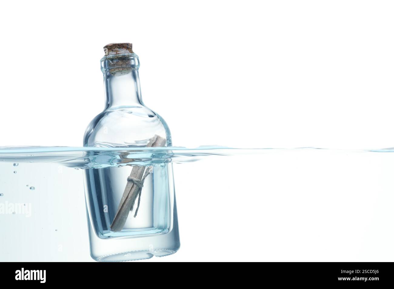 Corked glass bottle with rolled letter in water on white background ...