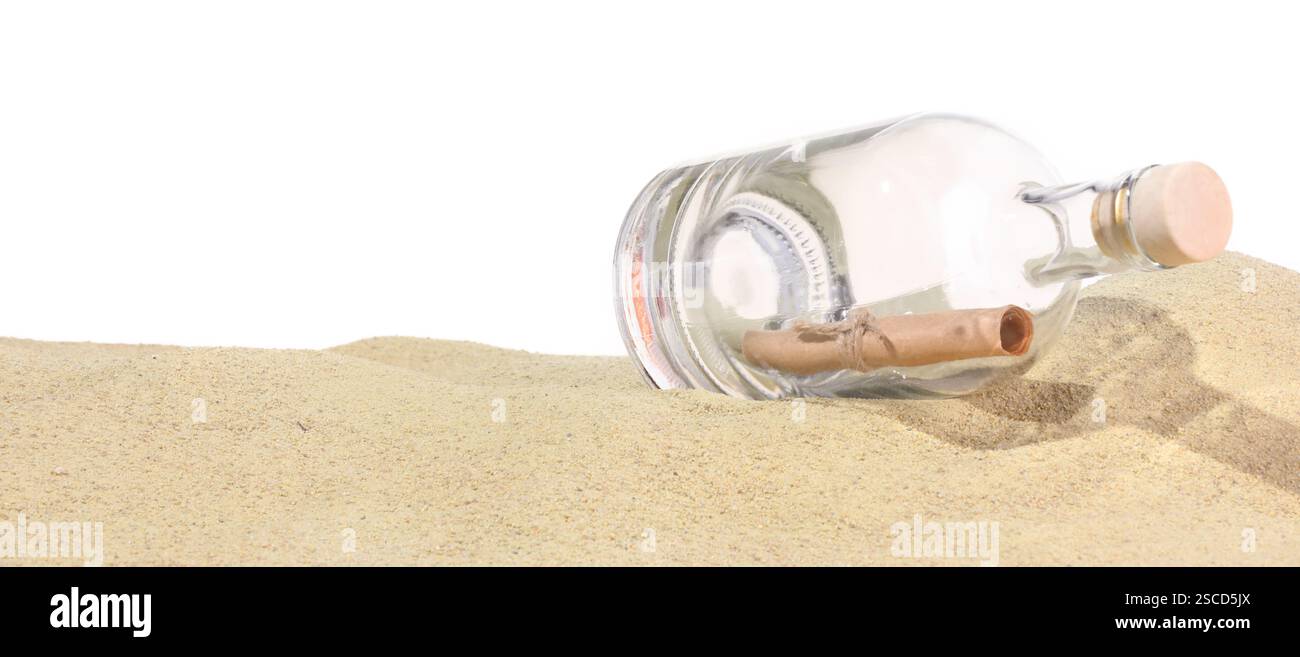 Rolled letter in corked glass bottle on sand against white background ...