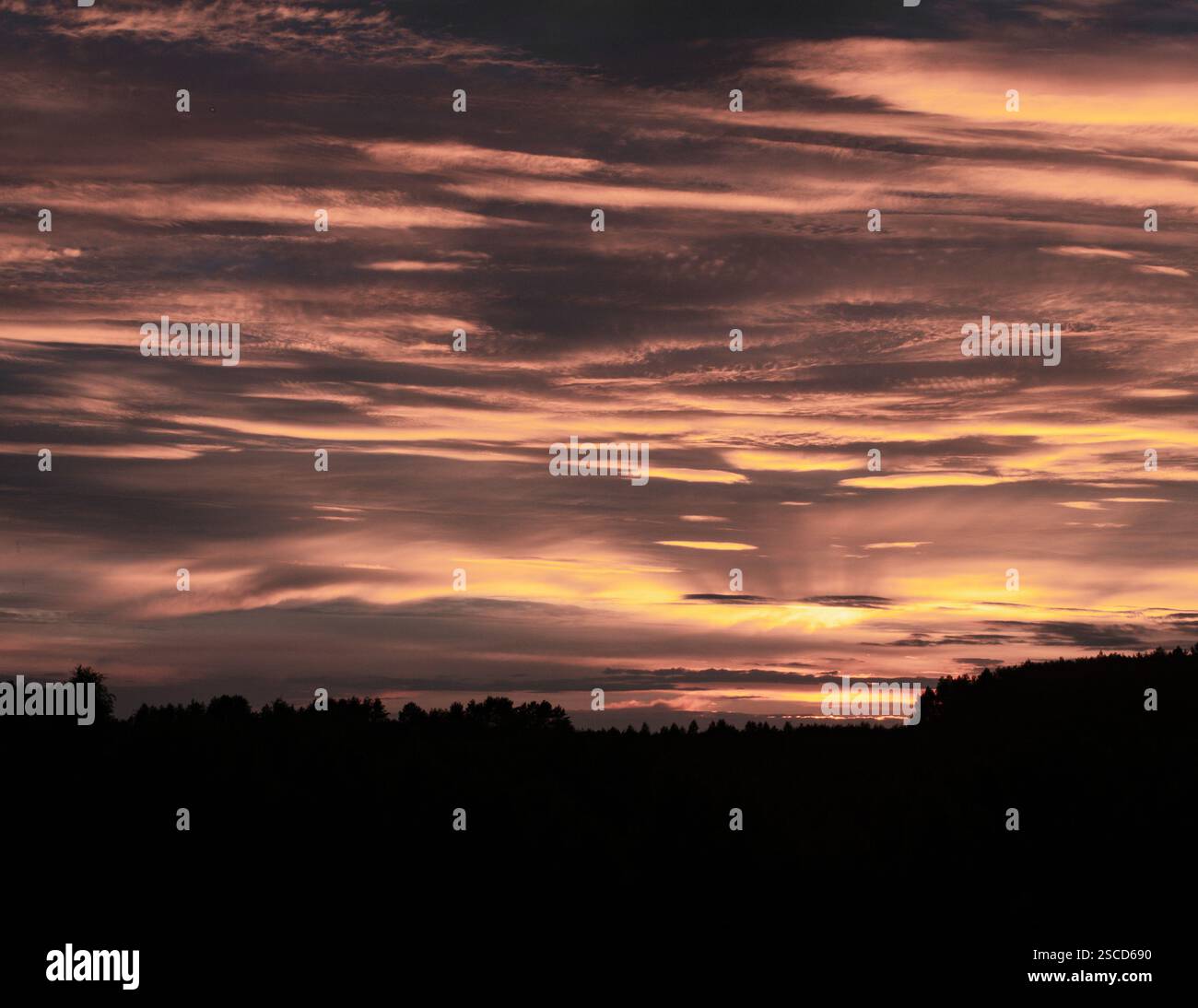 A breathtaking sunset sky filled with dramatic cloud formations and ...