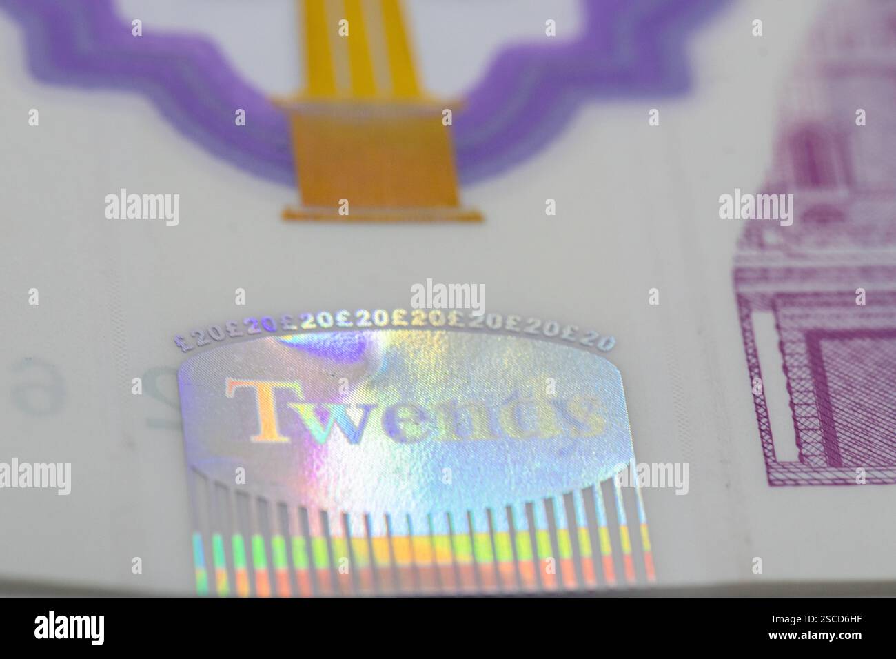 Close-up of a twenty-pound banknote detail, showcasing a holographic ...