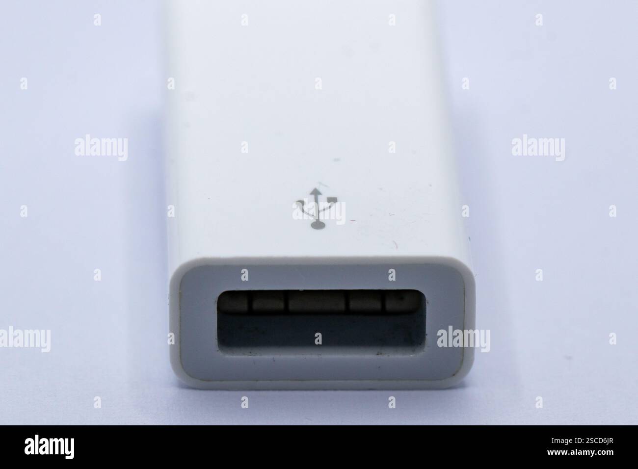 Close-up view of a white USB adapter, rectangular in shape, showing a ...