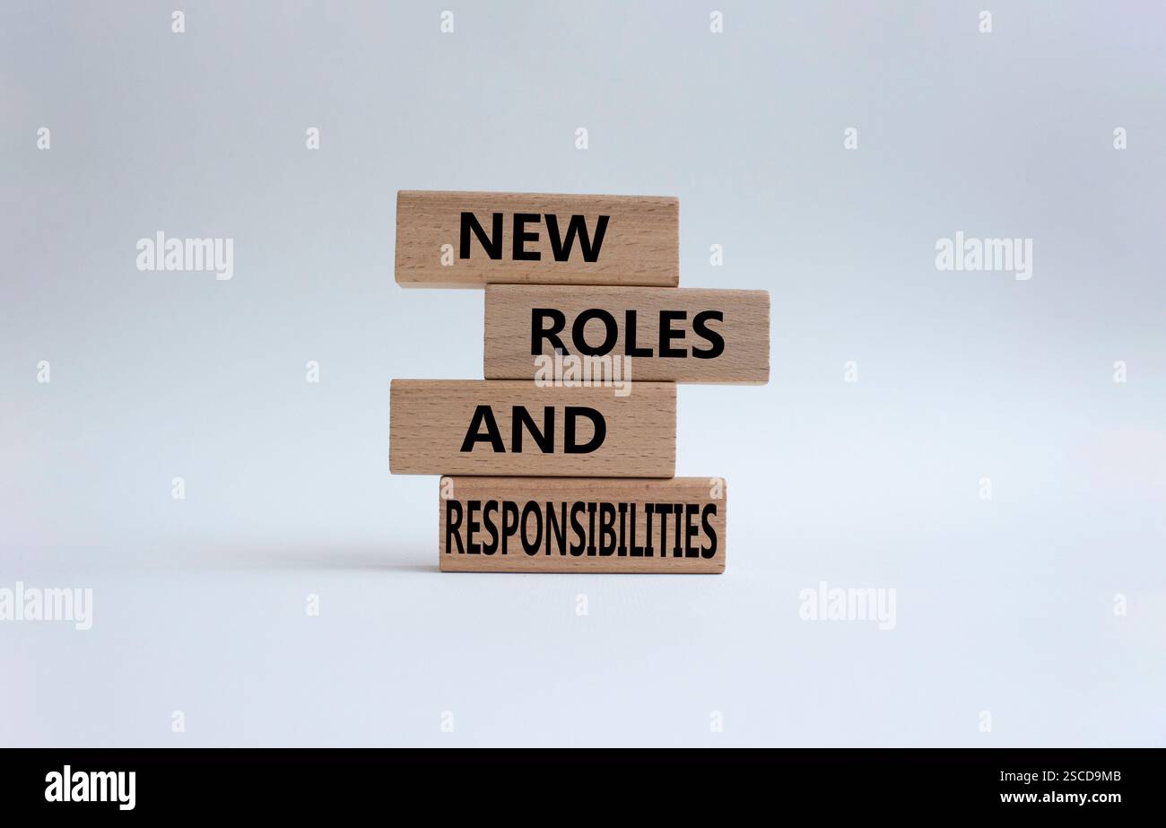 New roles and responsibilities symbol. Wooden blocks with words 'New ...