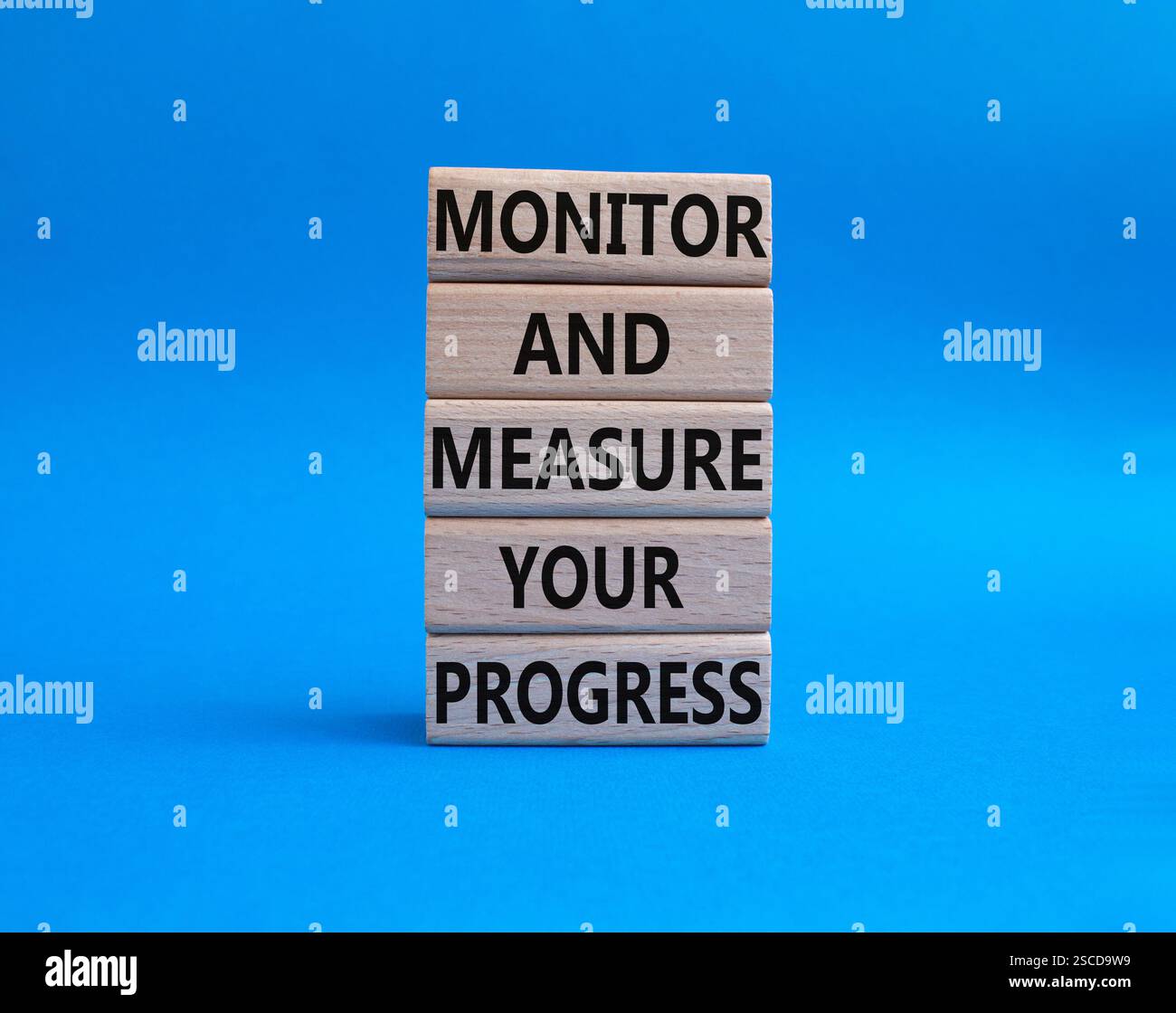 Monitor and Measure your Progress symbol. Wooden blocks with words ...