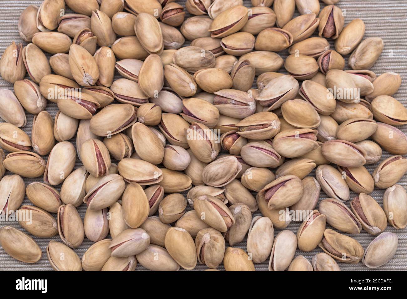Roasted pistachio nuts in shells. Natural food peanuts stacked background Stock Photo - Alamy