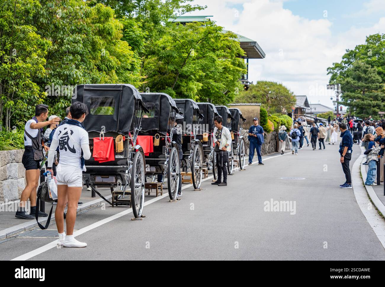 Kyoto, Japan - 05. 08. 2024:A row of rickshaws on the side of the road ...