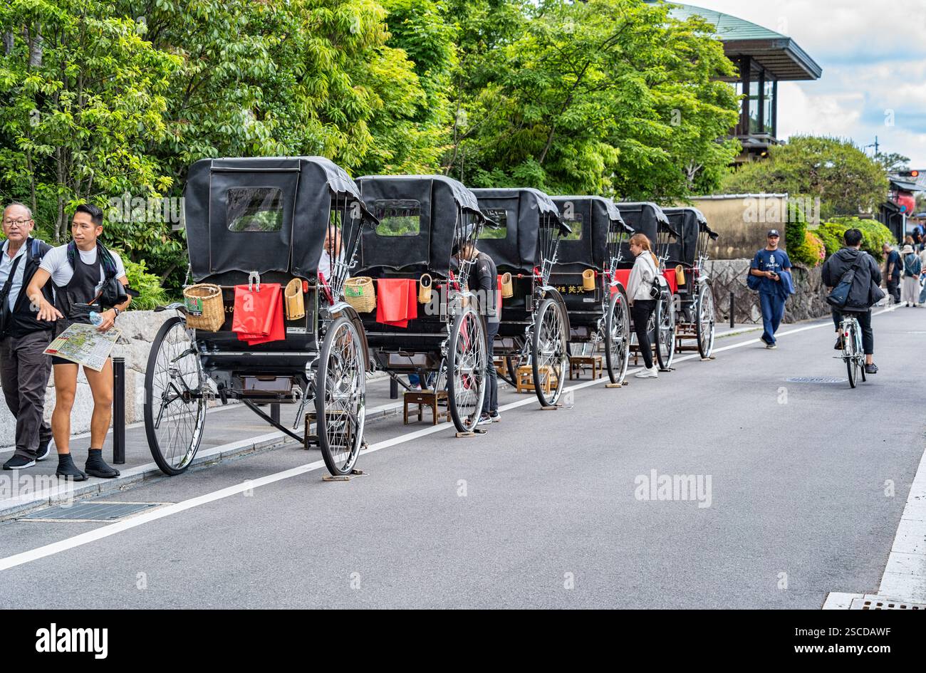 Kyoto, Japan - 05. 08. 2024:A row of rickshaws on the side of the road ...