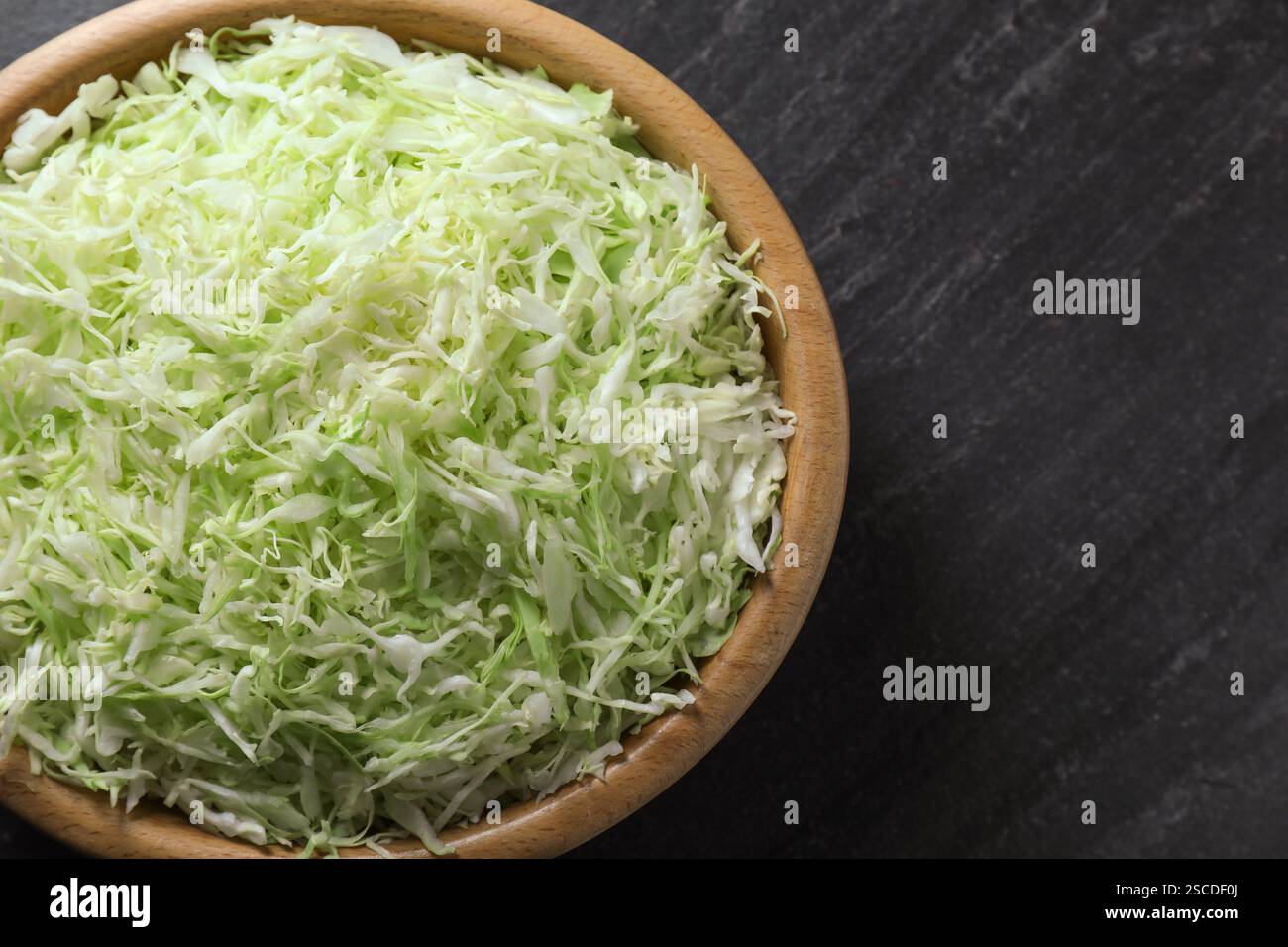 Fresh shredded cabbage on black table, top view Stock Photo - Alamy