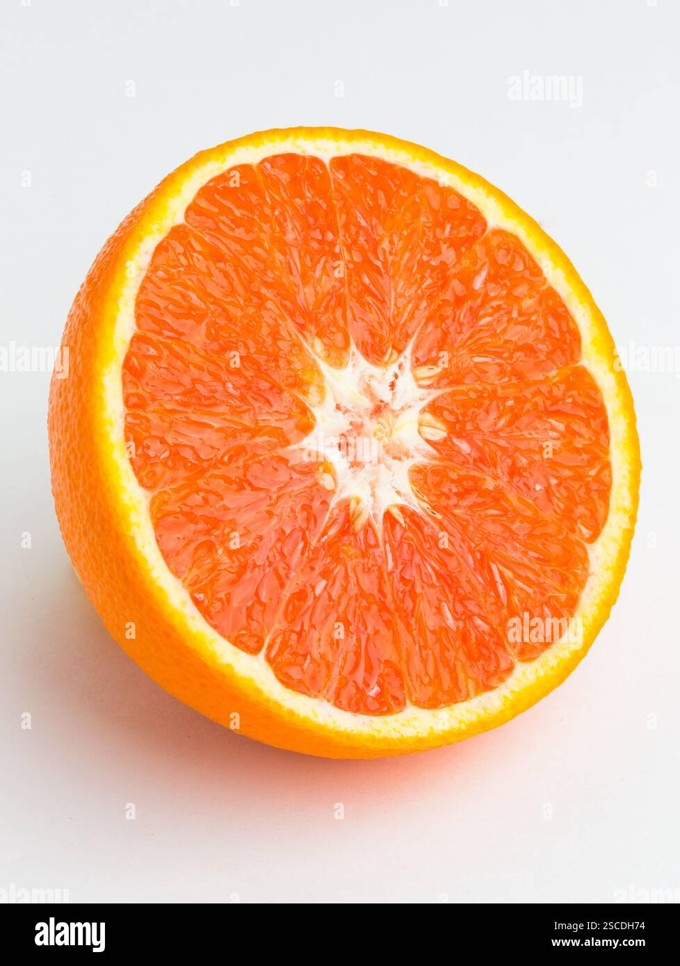 Red orange cut in half on white background Stock Photo - Alamy