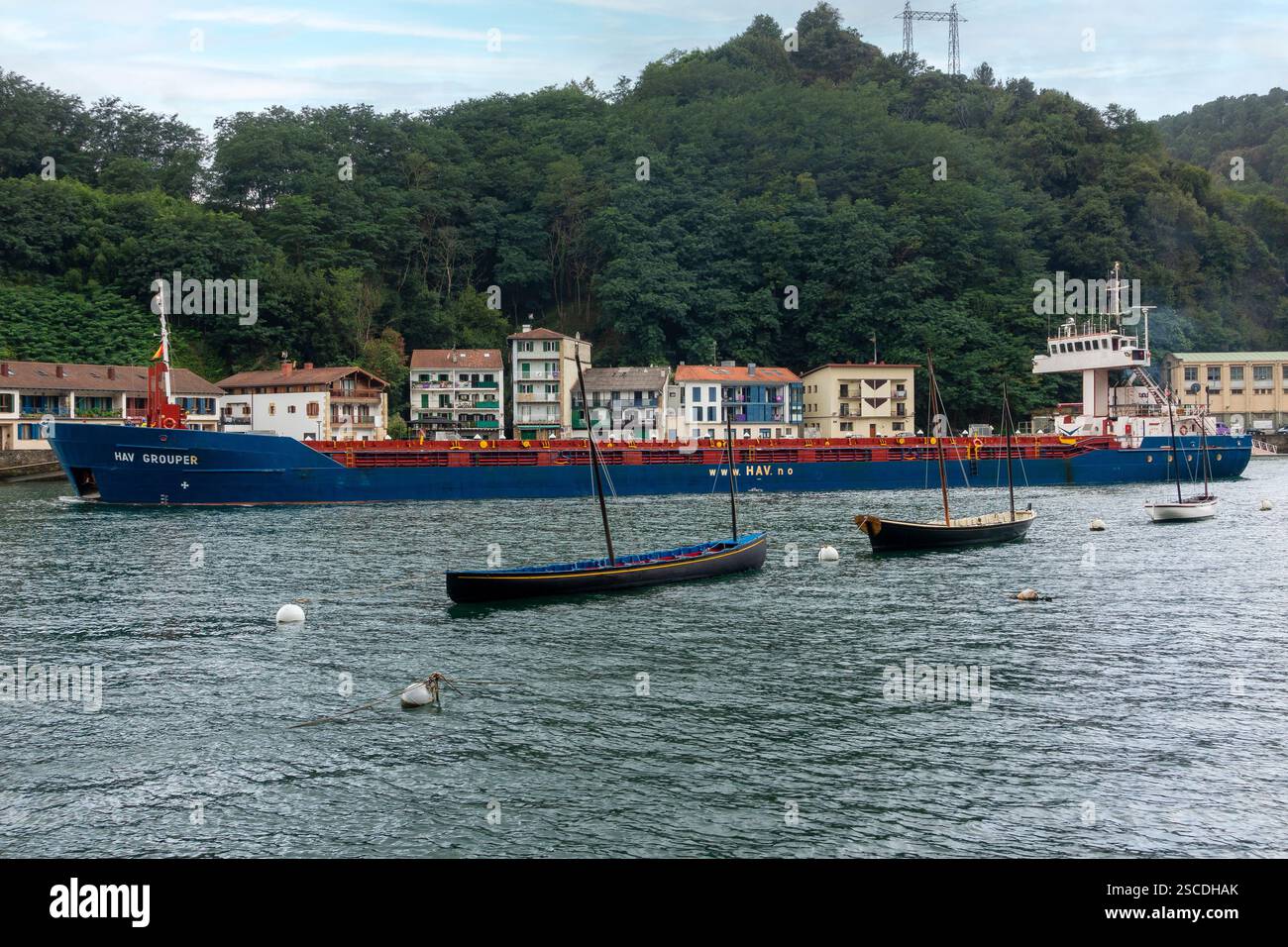 Heritage buildings and boats line the vibrant harbour of Pasaia along ...