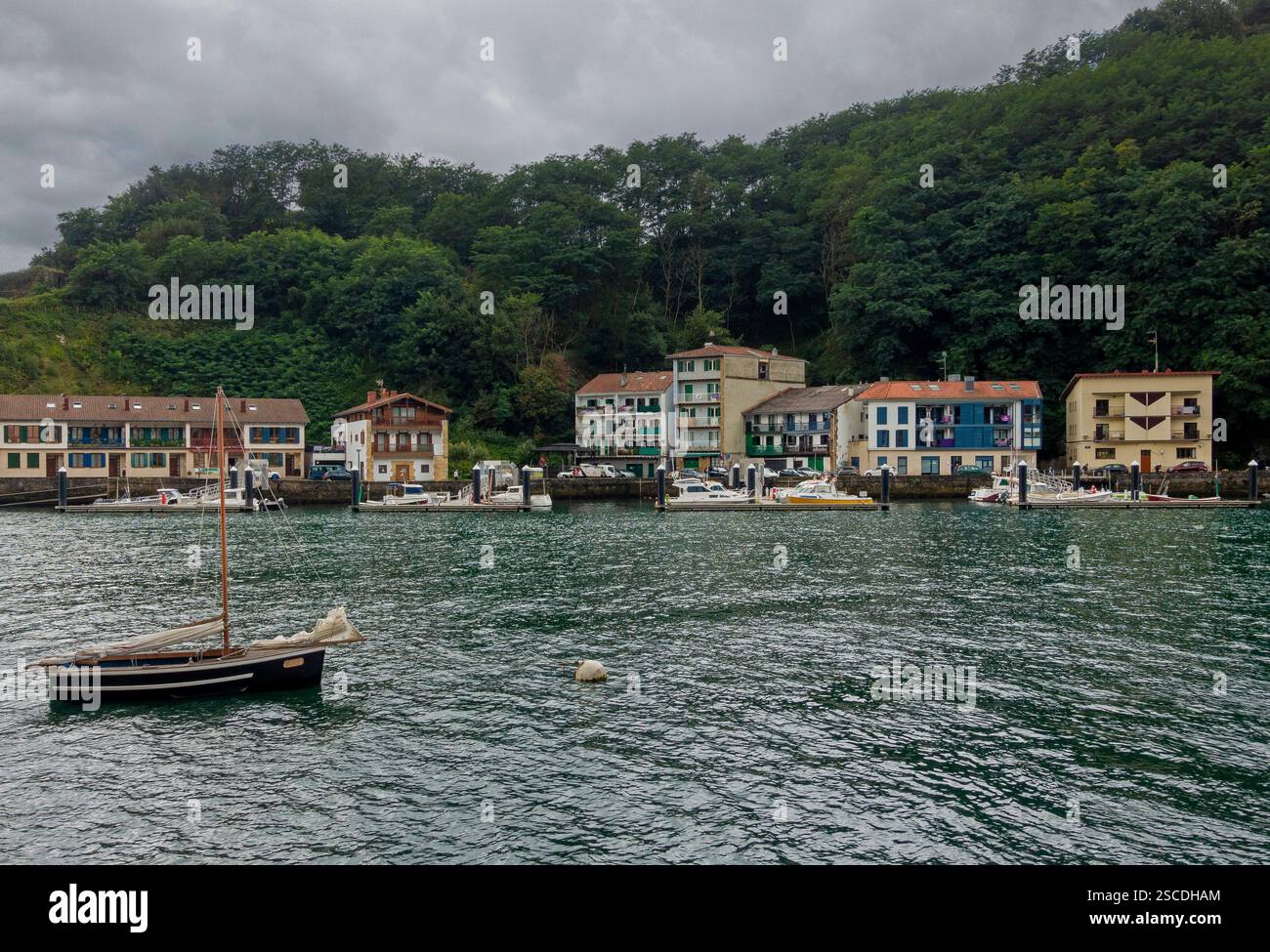 Heritage buildings and boats line the vibrant harbour of Pasaia along ...