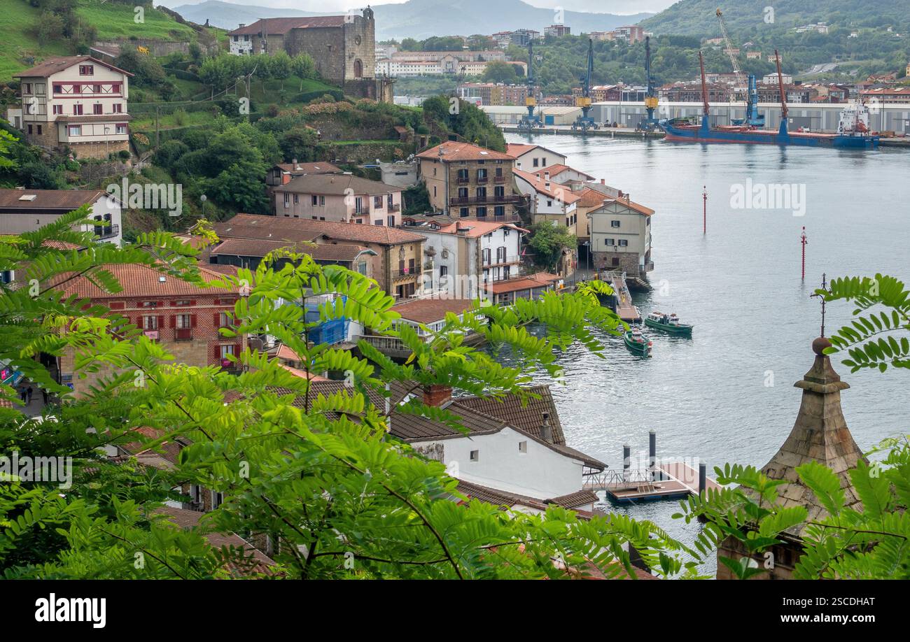 Heritage buildings and boats line the vibrant harbour of Pasaia along ...