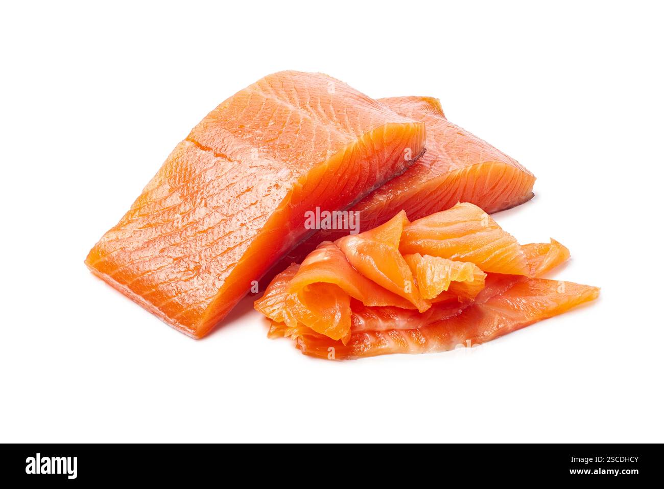 Two pieces of salmon or trout fillet and some thin slices isolated on ...