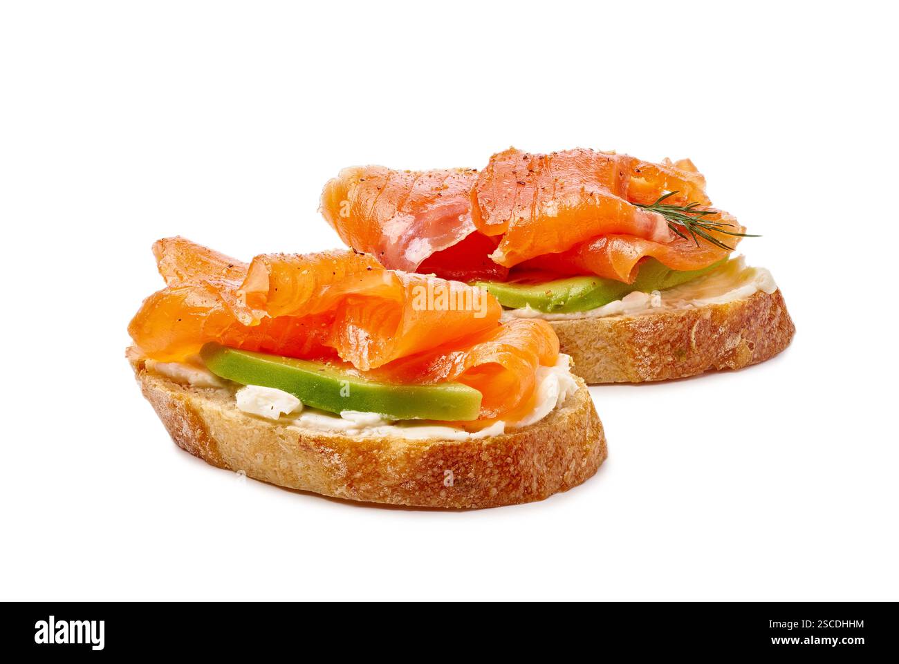 Tasty canapes with salmon, avocado and cream cheese isolated on white ...