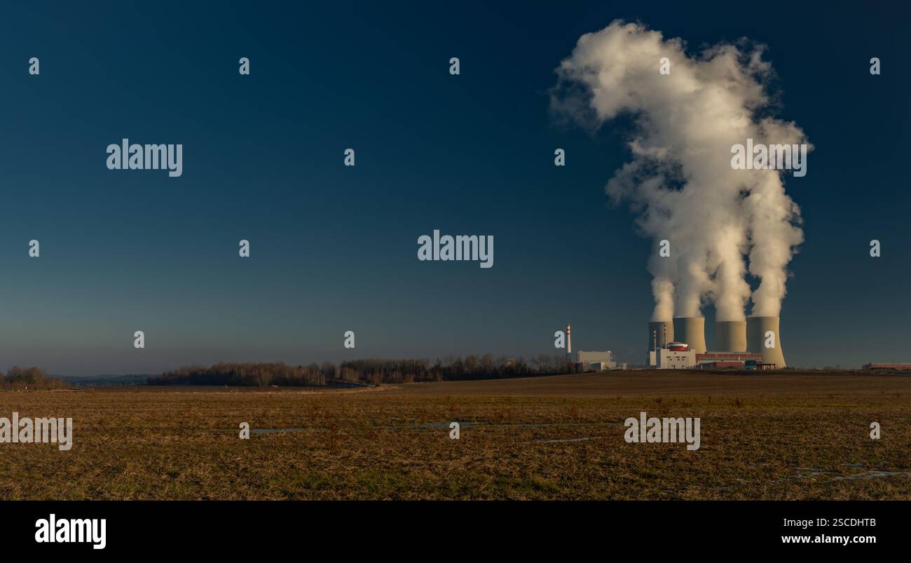 Big chimneys with white smoke in winter sunny day near nuclear power ...