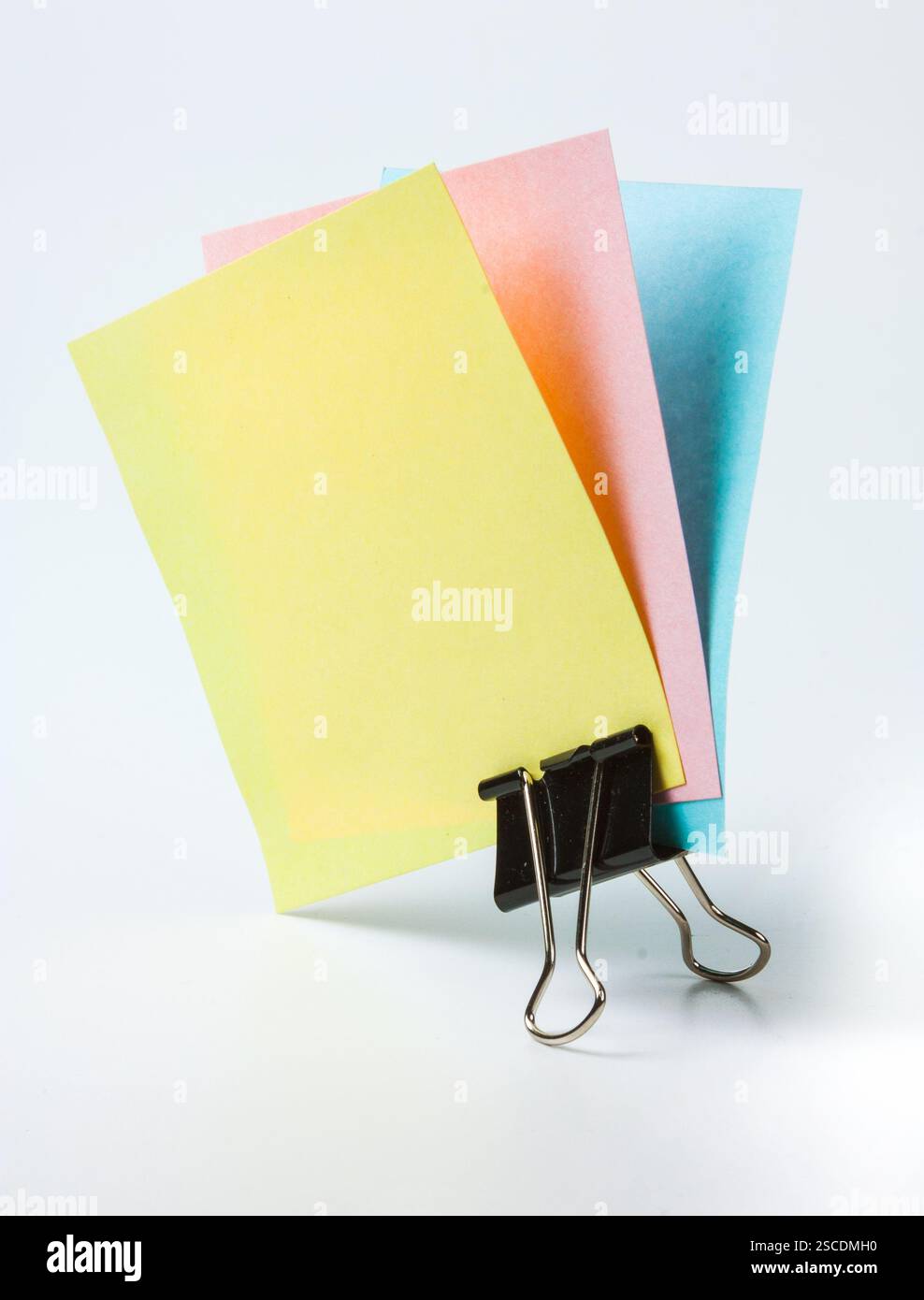 Paper notes on a stand on white background Stock Photo - Alamy