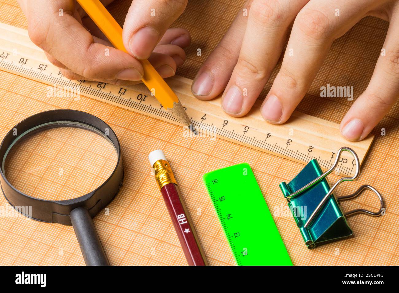 draftsman draws on a ruler on the graph paper Stock Photo - Alamy