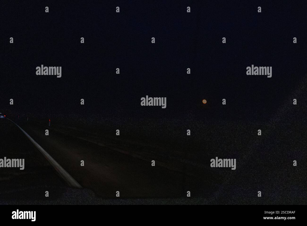 night illuminated highway with cars on a full moon according to the ...