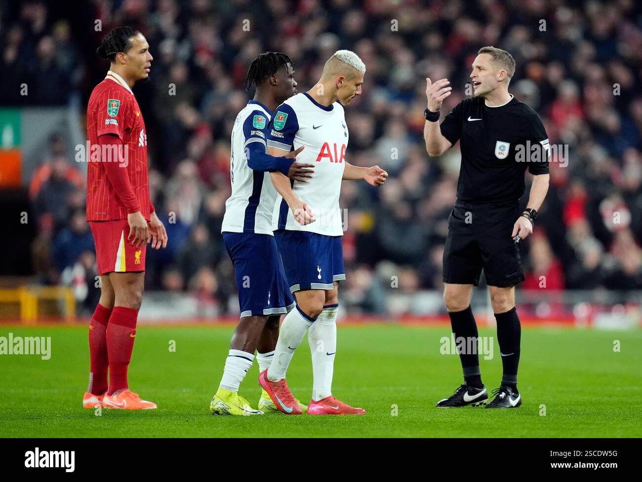 Referee Craig Pawson (right) speaks to players Liverpool's Virgil van ...