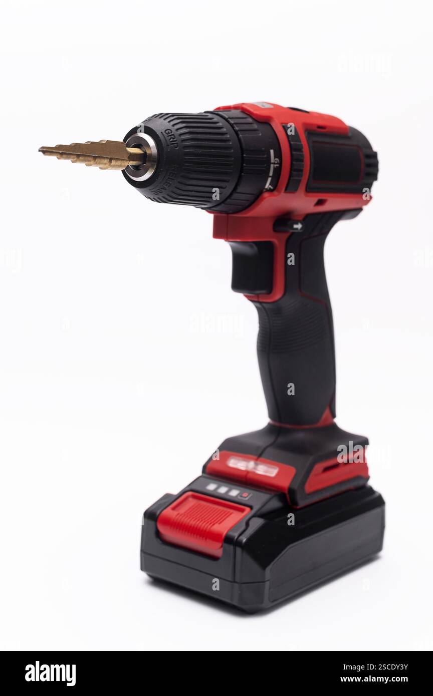 electric screwdriver with a cone drill on a white background. vertical ...