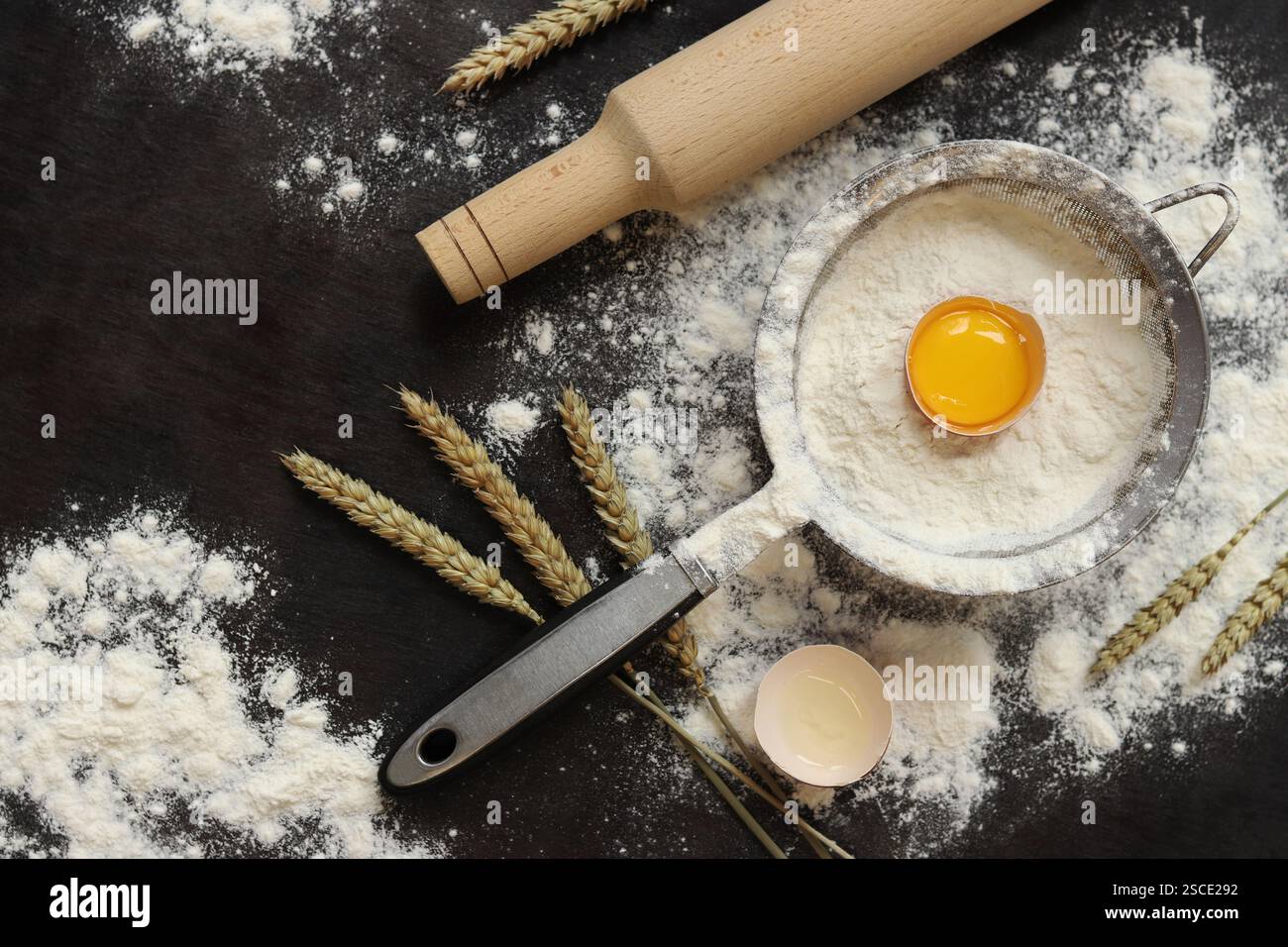 Baking process background, top view. Flour with raw egg, rolling pin ...