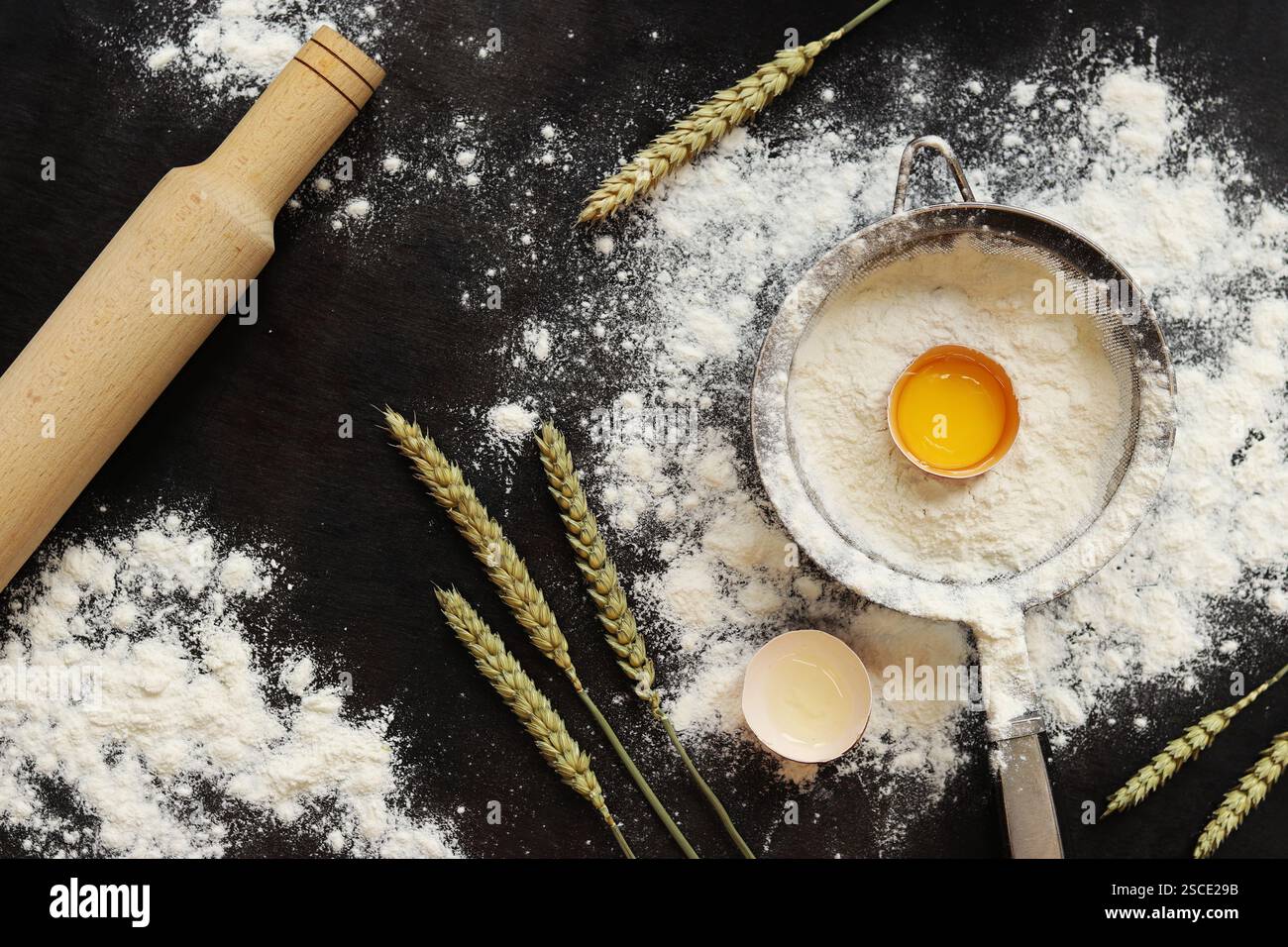 Baking process background, top view. Flour with raw egg, rolling pin ...