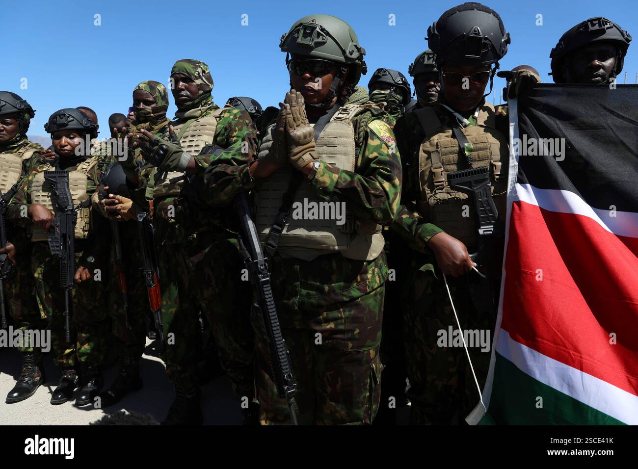 Kenyan police, who are part of a UN-backed multinational force, pray on ...