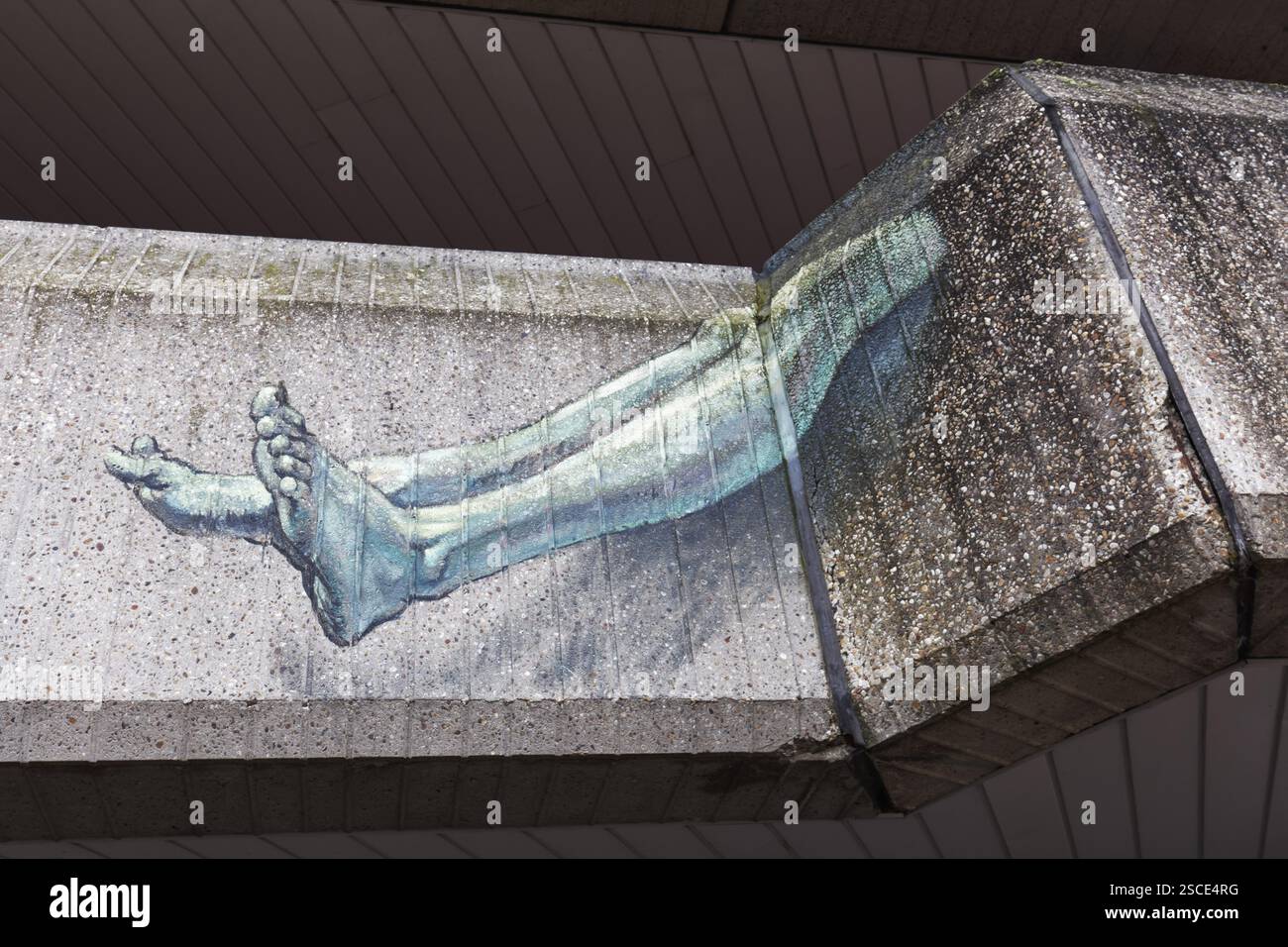 Human legs protruding from a concrete facade, surreal graffiti on the ...