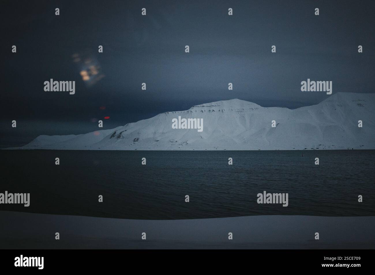 View across snowy fjord out of car window in the arctic, Longyearbyen ...
