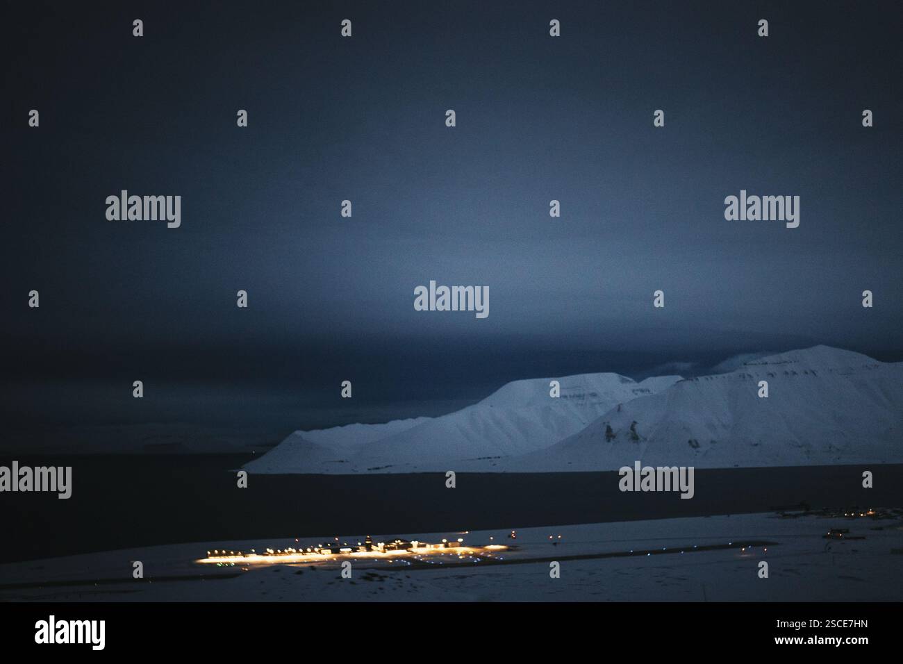 View across airport and fjord in the polar night in Longyearbyen ...