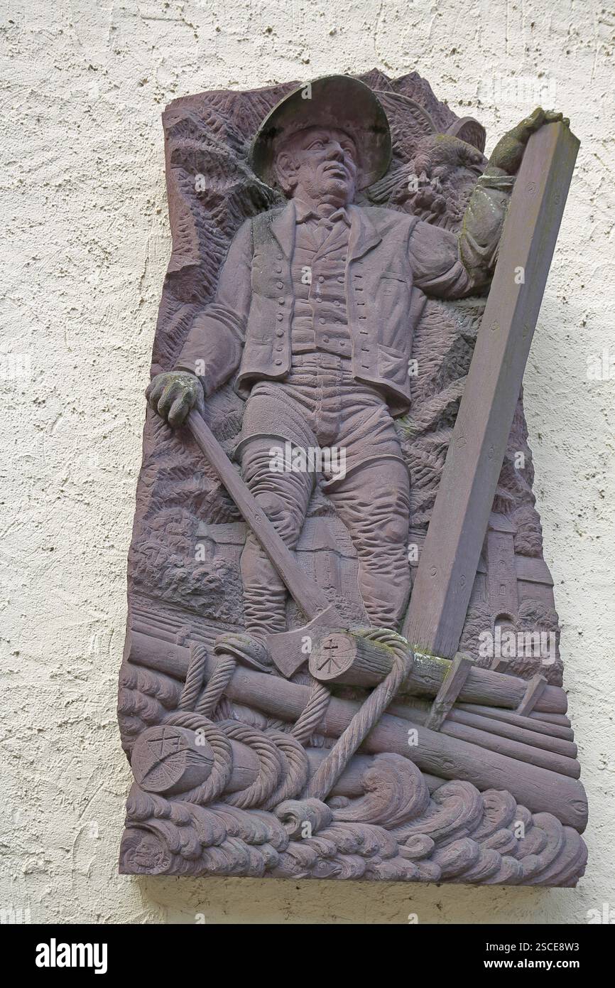 Monument to historical rafting, male figure with axe, ropes on raft ...