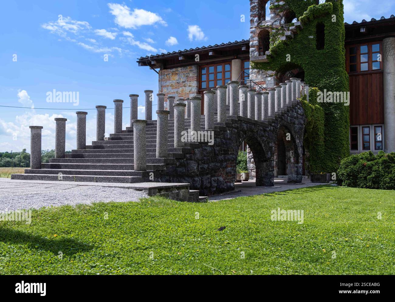 Rustic stone steps leading to a majestic arched doorway of a historic ...