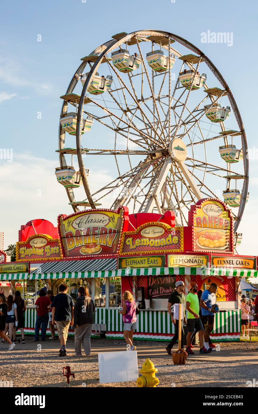 A Ferris wheel stands above the Classic Bakery food vendor at the Allen ...