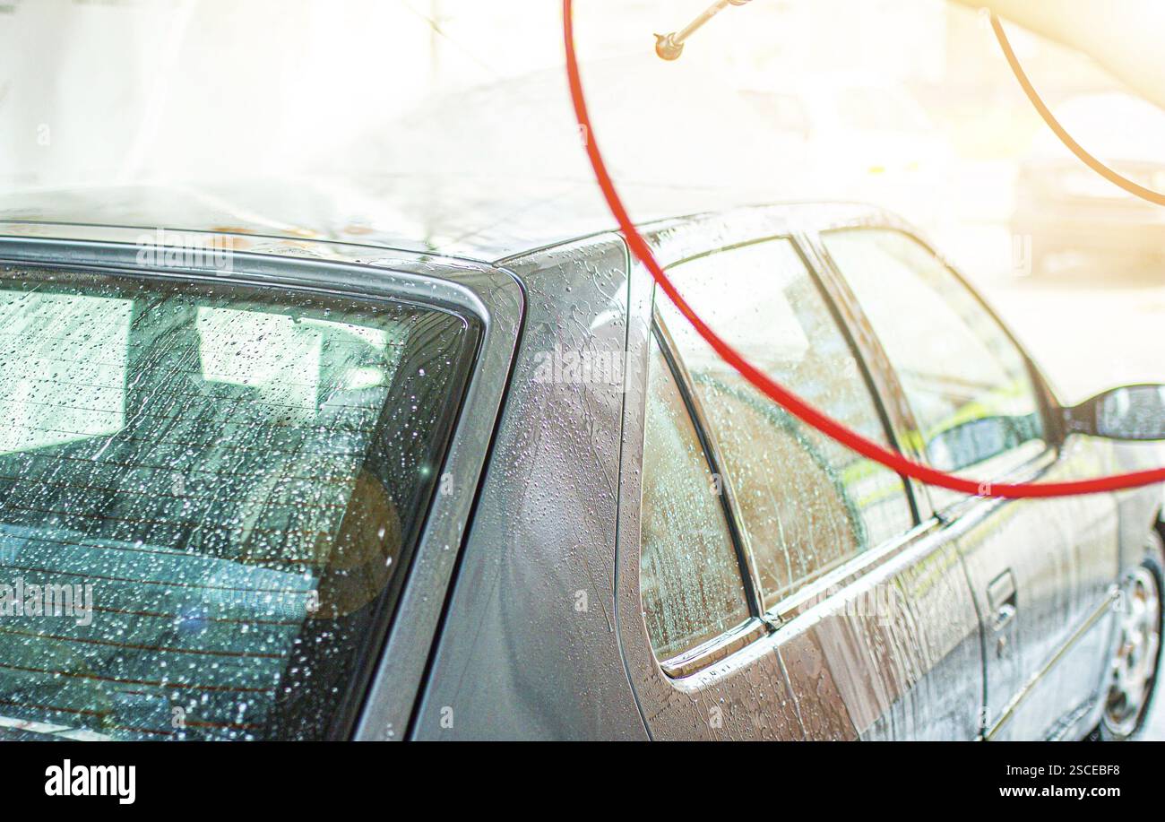 Car wash scene where water droplets reflect sunlight on the roof Stock ...