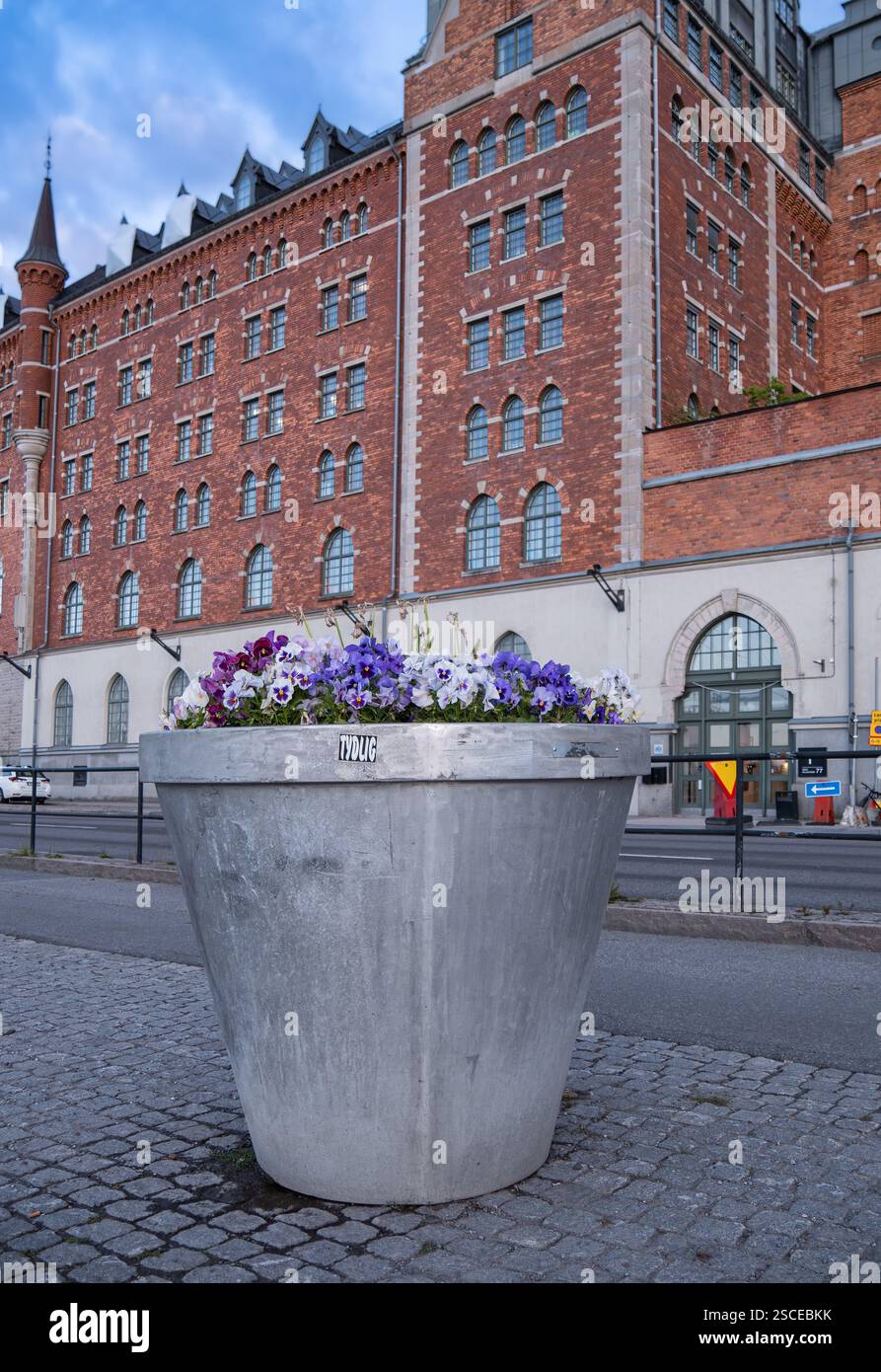 Stockholm, Sweden - 13 June 2024: A large concrete flower pot filled ...