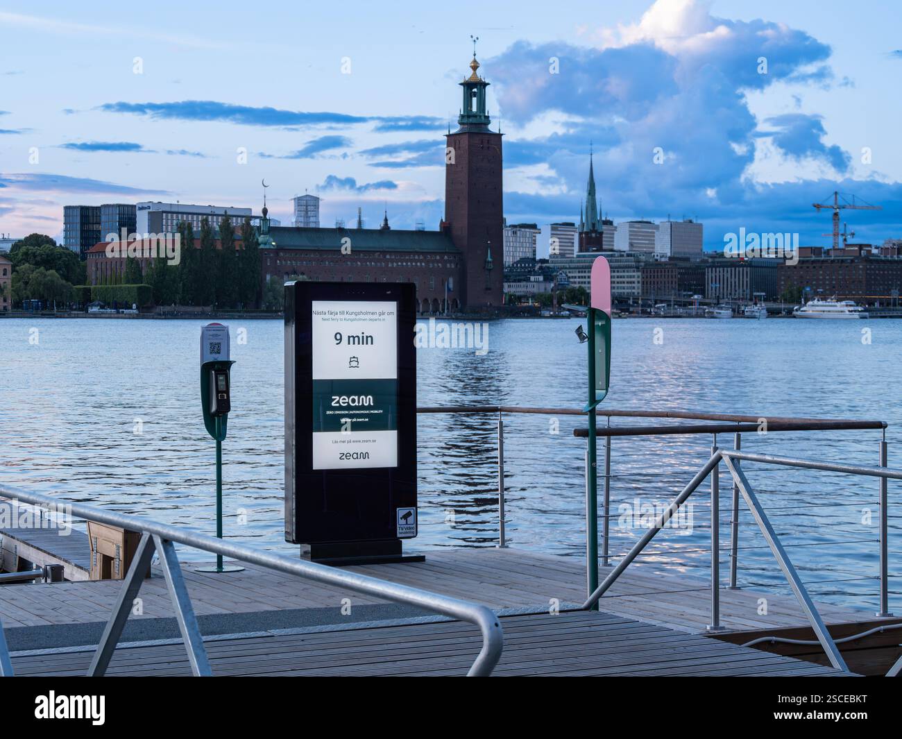 A digital sign on a dock displays a 9-minute wait time for a boat ...