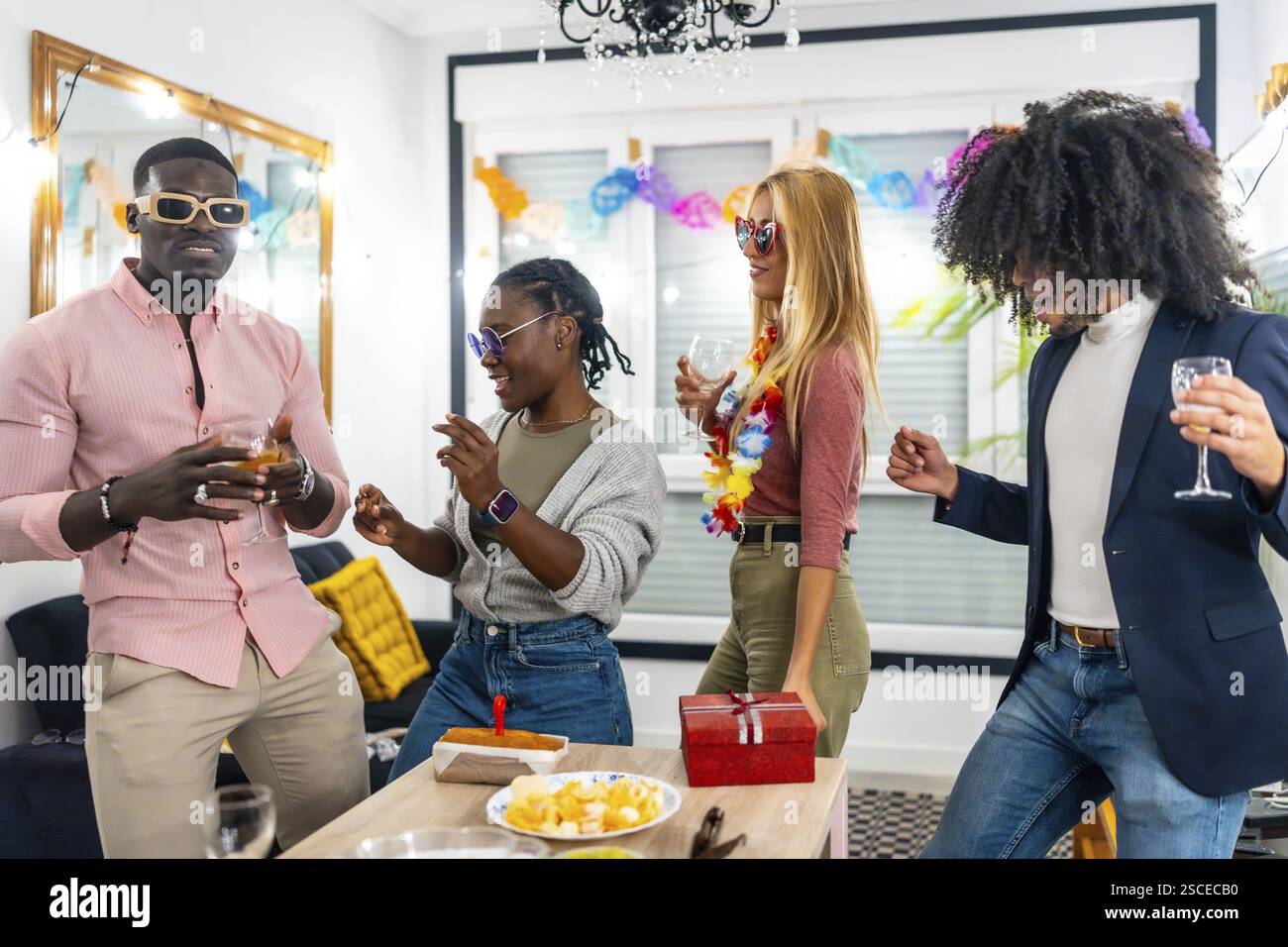 Multiracial friends dancing together during party at home celebrating ...