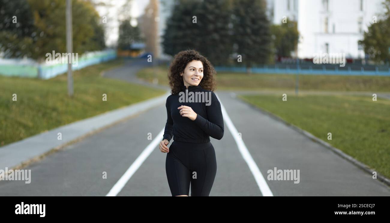 A woman running, conveying joy and energy on the track Stock Photo - Alamy