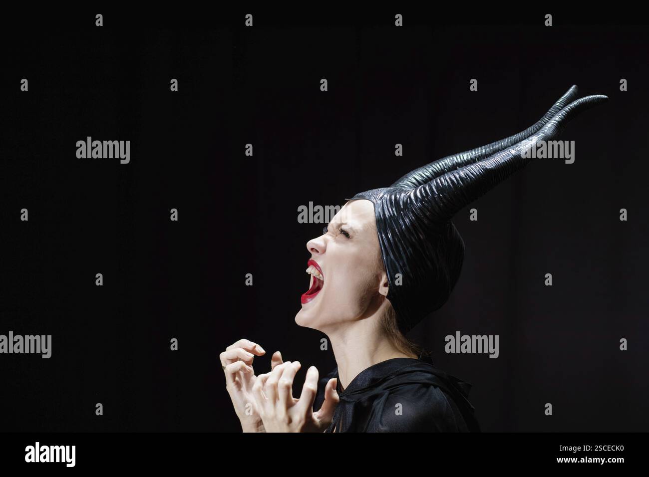 A woman in a horned costume, expressing a dramatic scream Stock Photo ...