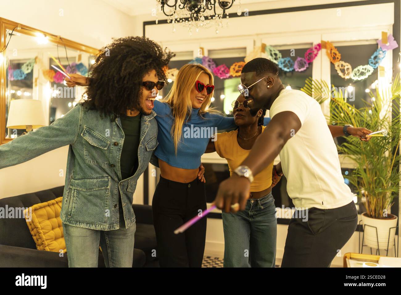 Multi-ethnic young friends laving fun in a home night party Stock Photo ...