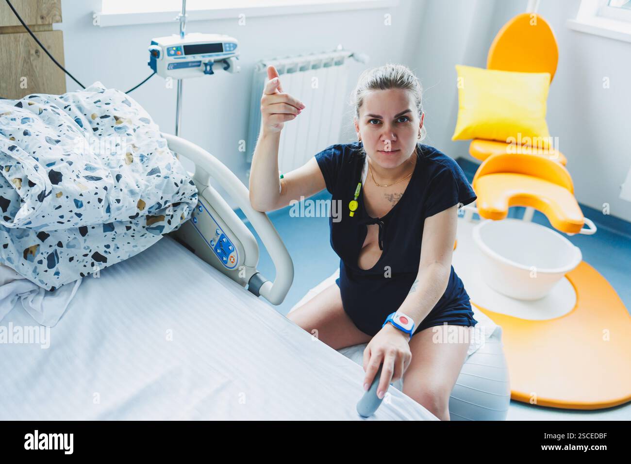 A woman in the delivery room feels contractions and severe pain in her ...