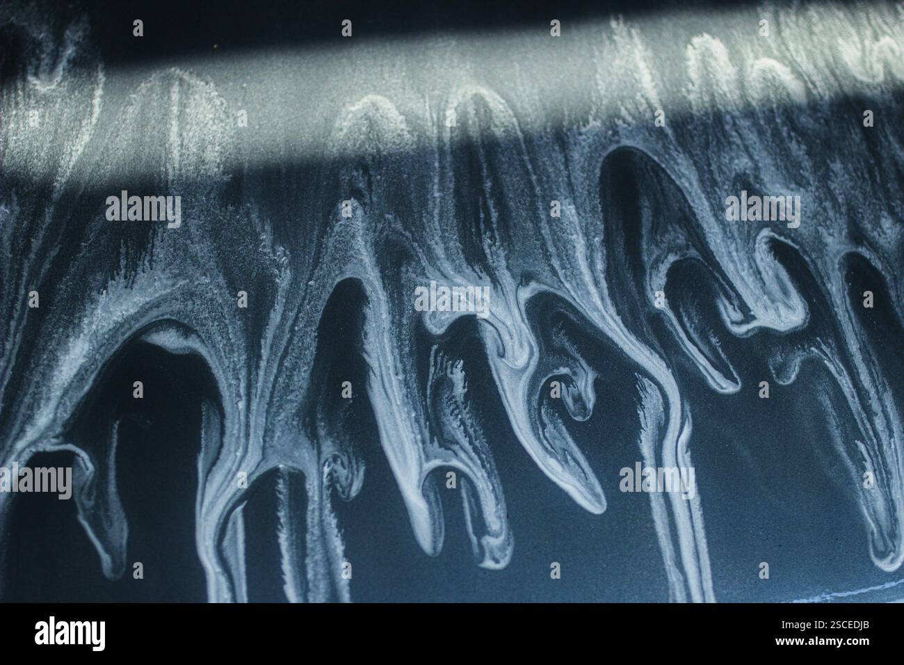 Abstract texture with white watery patterns over a dark surface Stock ...