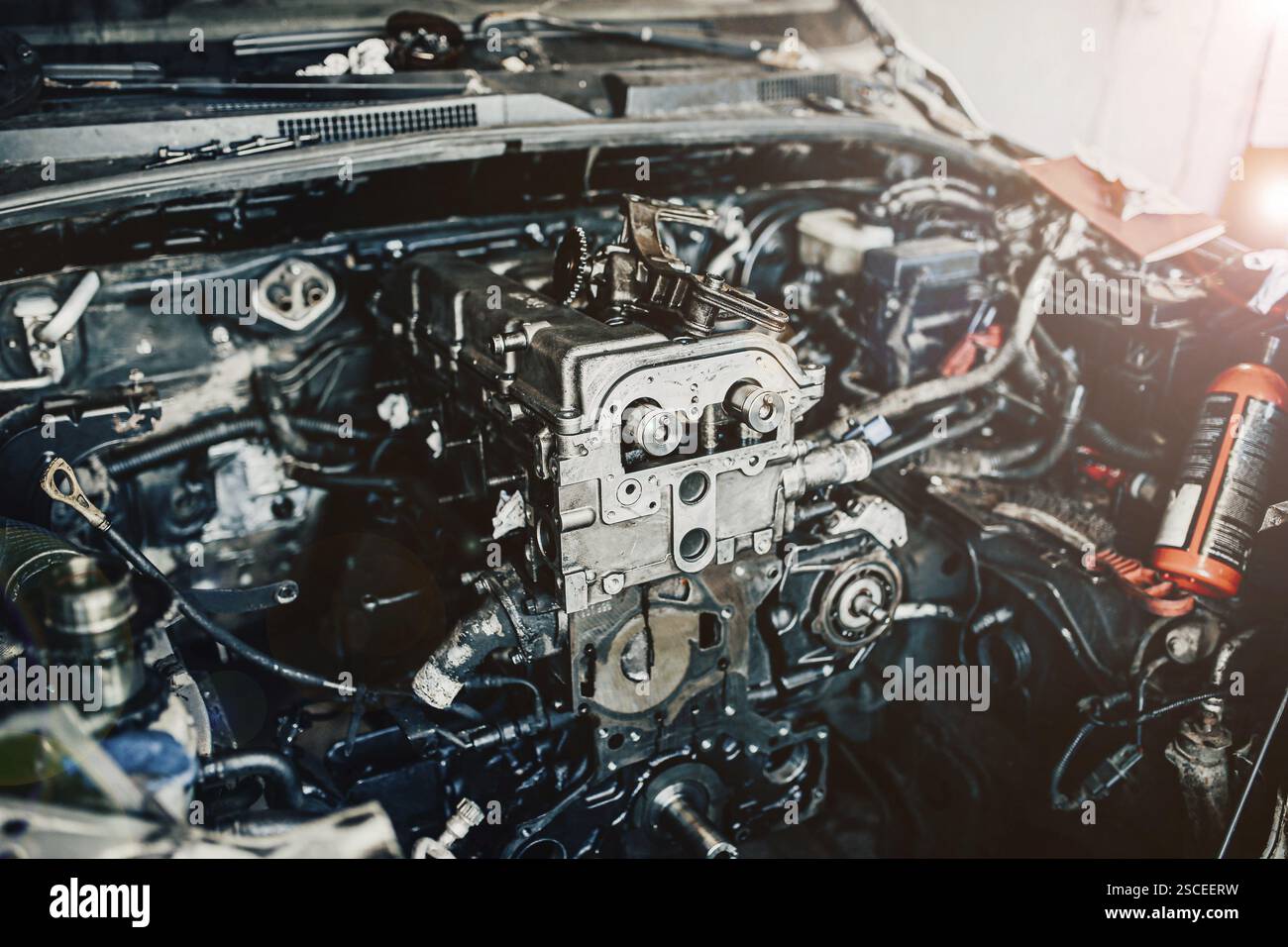 Automobile engine in the process of being repaired, illuminated with ...