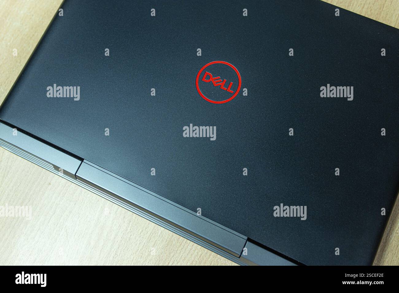 Black Dell laptop closed with a visible logo on a wood surface Stock ...