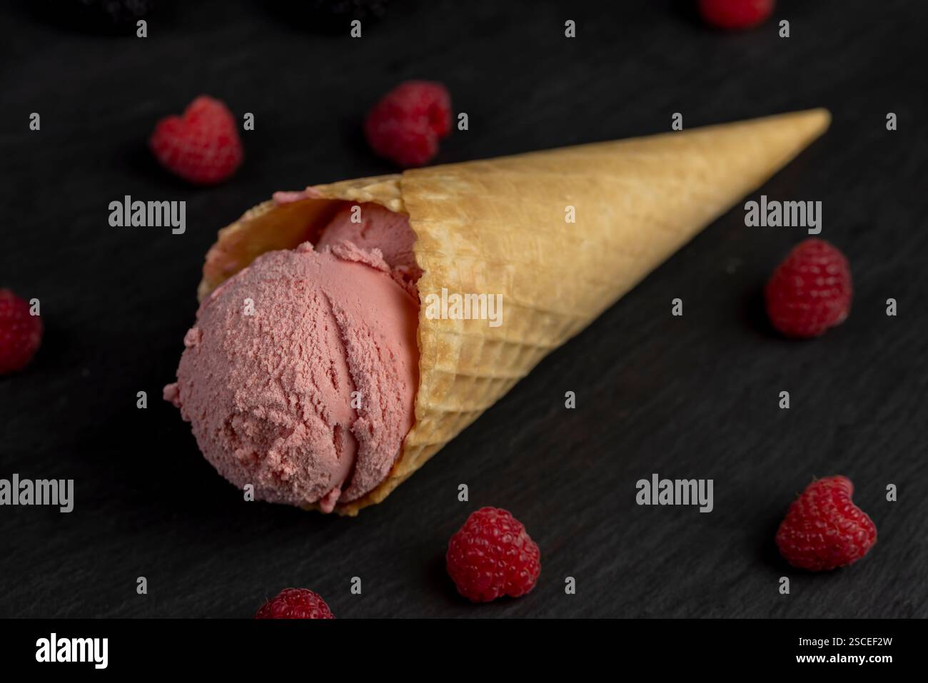 creamy raspberry flavored ice cream with red raspberry berries on a ...