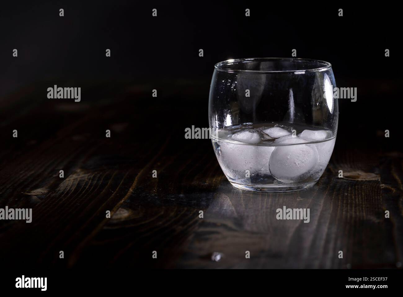 glass with cold sparkling water close up, cold mineral water with a lot of gases and bubbles ...