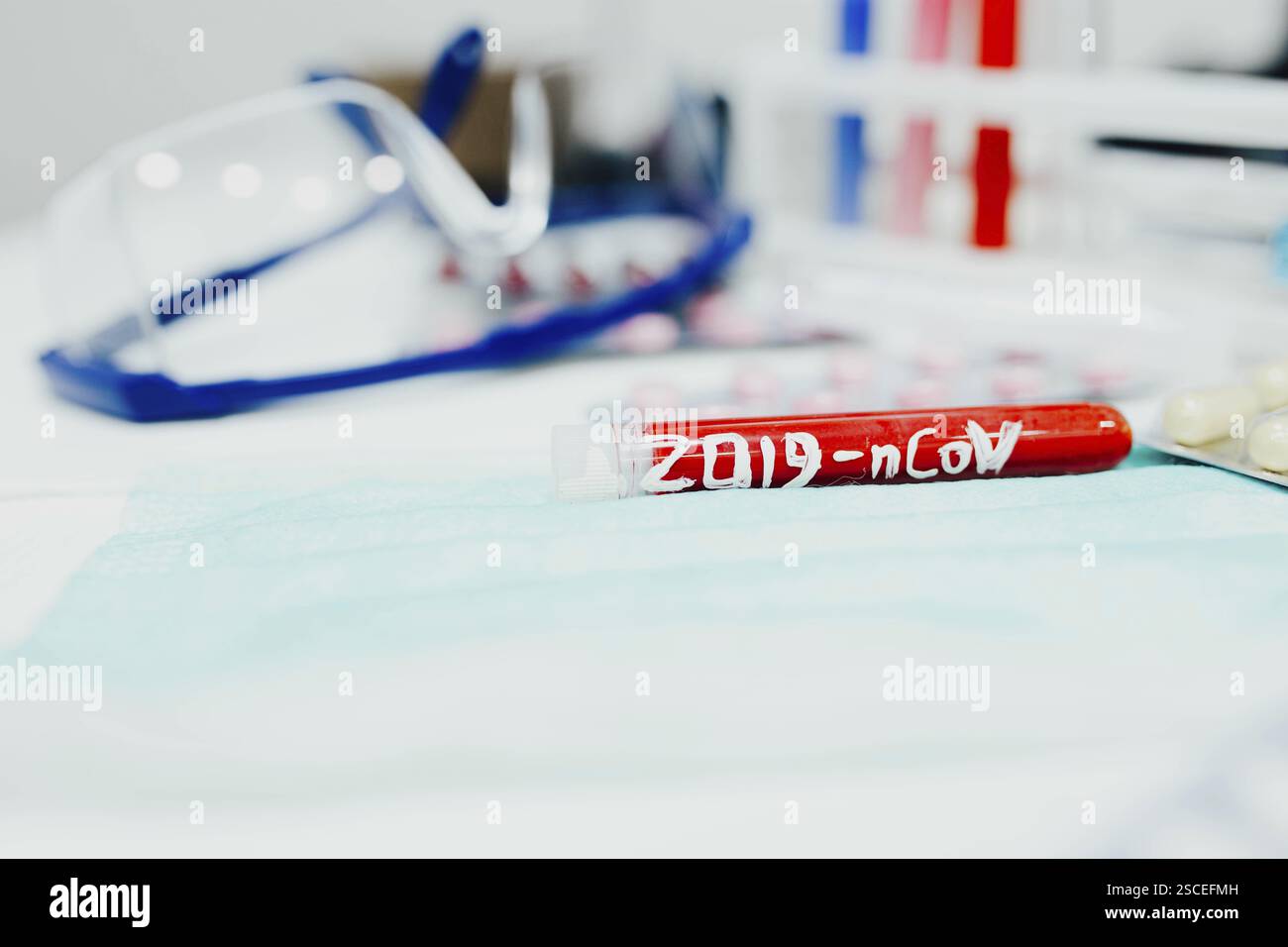 Test tube labeled 2019-nCoV surrounded by laboratory equipment Stock ...