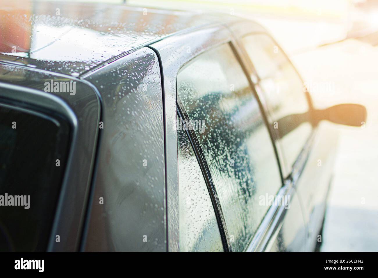 Car in wash with water droplets on windows reflecting sunlight Stock Photo - Alamy
